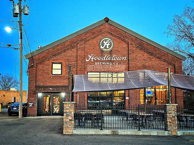 Hoodletown Brewing Company transforms a historic brick building into a gathering spot for craft beer enthusiasts. That patio has hosted countless first dates and friendly debates.