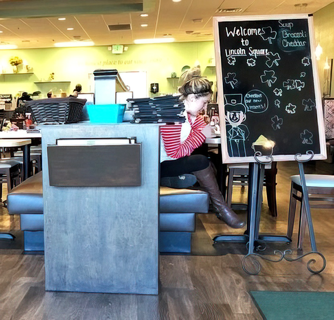 That welcoming chalkboard practically sings breakfast songs, inviting you into a world where every meal feels like Saturday morning.