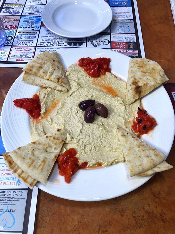 Hummus that doesn't just sit on the plate&mdash;it lounges luxuriously, surrounded by its entourage of warm pita, roasted peppers, and plump olives.