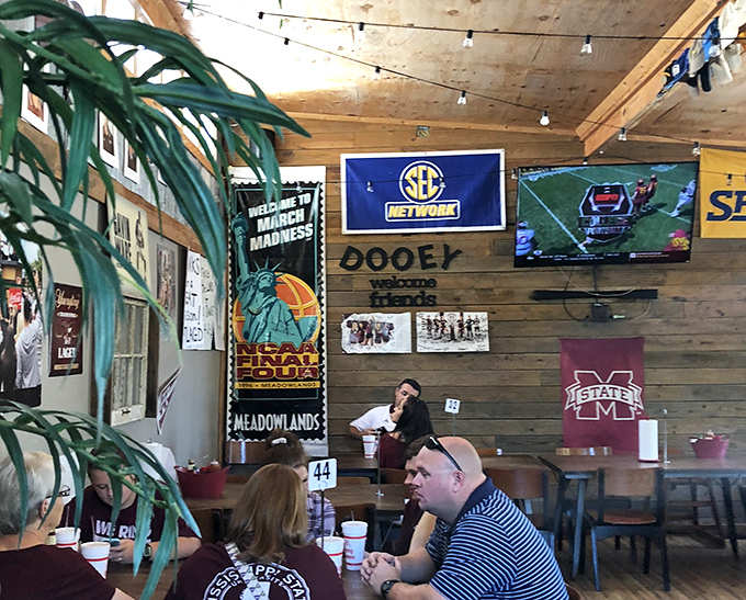 "Dooey welcomes friends" says the sign, and the Mississippi State flags confirm you're in Bulldog territory where BBQ is serious business.