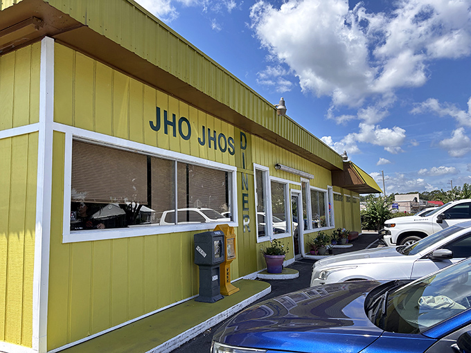 The sunshine-yellow exterior of Jho Jho's promises food with personality in a building that refuses to blend into the background.