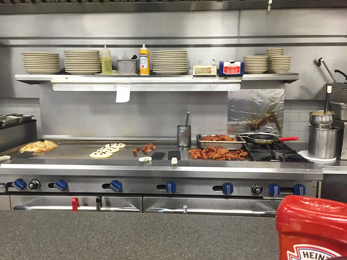 The grill where breakfast magic happens &ndash; bacon crisping, eggs sizzling, and pancakes achieving that perfect golden-brown that makes morning people out of night owls.