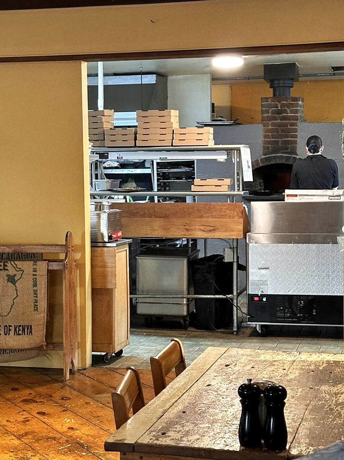 A glimpse into the kitchen reveals the brick oven where pizza dreams come true and sourdough achieves its perfect crackling crust.