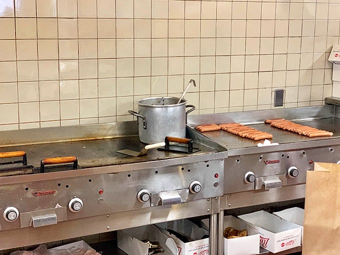 Hot dogs lined up like soldiers awaiting their delicious destiny. This grill has probably seen more action than most five-star restaurant kitchens.