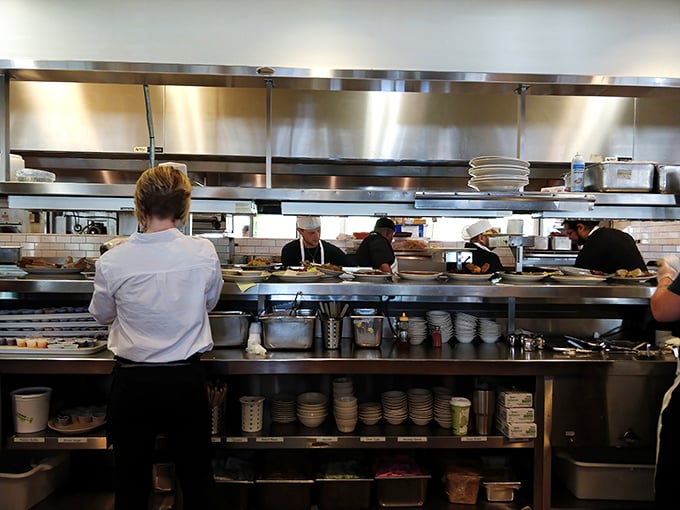 The kitchen's gleaming stainless steel and organized chaos reveal the secret behind Monument Cafe's consistency&mdash;precision disguised as down-home cooking.