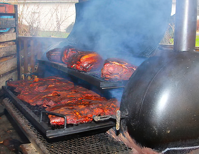 BBQ magic happens here. That smoke isn't just for show&mdash;it's the aromatic evidence of patience and craftsmanship in every bite.