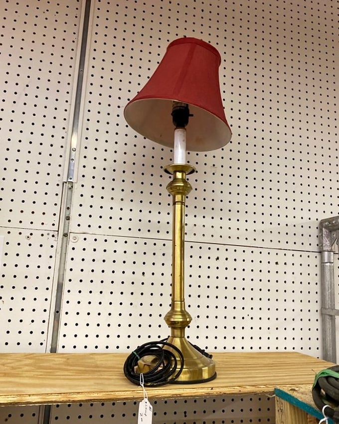 This brass lamp with its jaunty red shade isn't just illuminating a room &ndash; it's lighting up memories of grandma's reading corner from 1975.