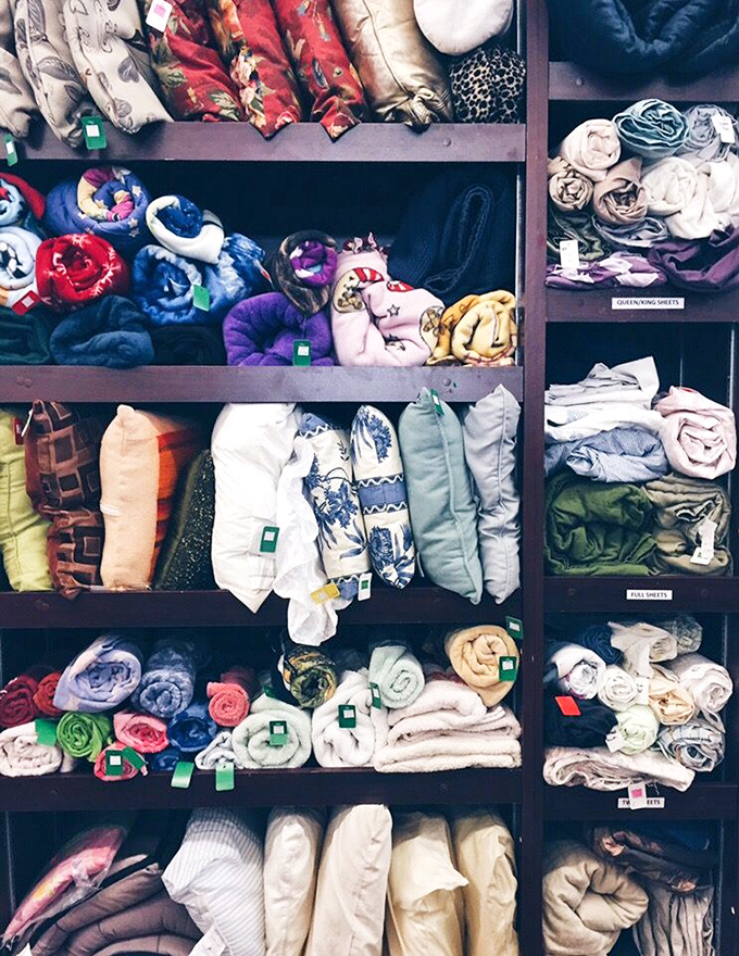 The linen section: organized by color like a Martha Stewart fever dream. Those floral pillowcases have seen things.