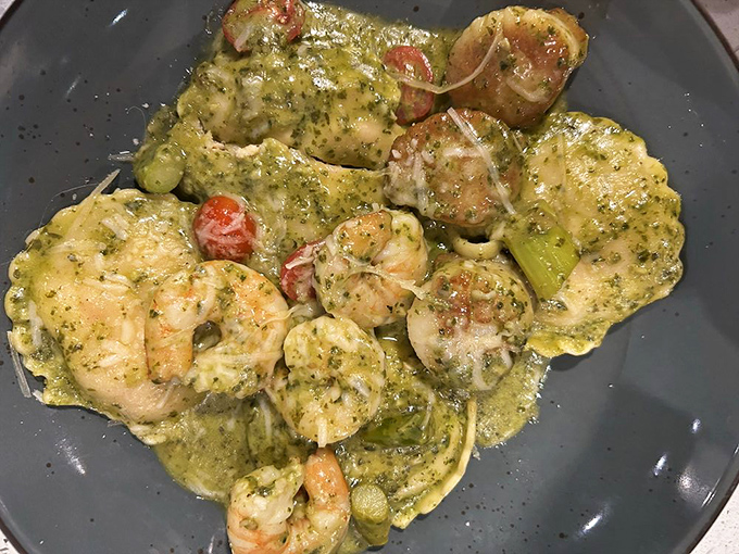 A seafood medley in green sauce that looks like it was blessed by Poseidon himself—shrimp and scallops having their best day ever.