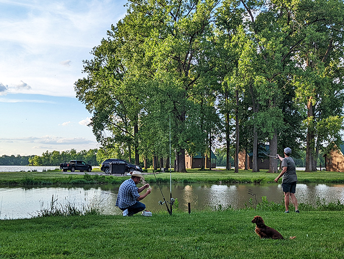 Two fishermen and a loyal dog demonstrate the art of patience at the lake's edge, where time slows down and worries seem to float away.