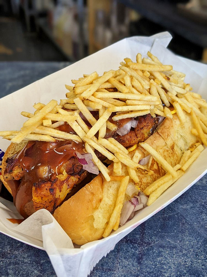 This creation looks like it was designed by someone who believes that if some fries on a hot dog is good, a mountain is better.