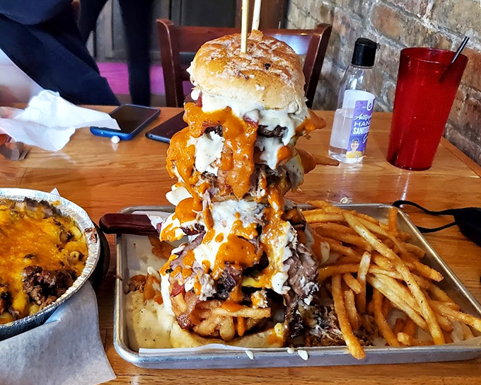 This towering sandwich isn't food—it's architecture. A skyscraper of meat, cheese, and sauce that requires both hands and a strategy.