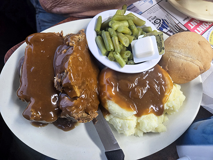 Meatloaf swimming in gravy so good you'll want to write poetry about it, paired with mashed potatoes that could make a grown man weep.