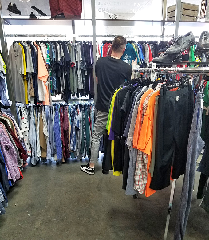 A shopper contemplates his next fashion move, surrounded by enough options to dress a small Texas town for a month.