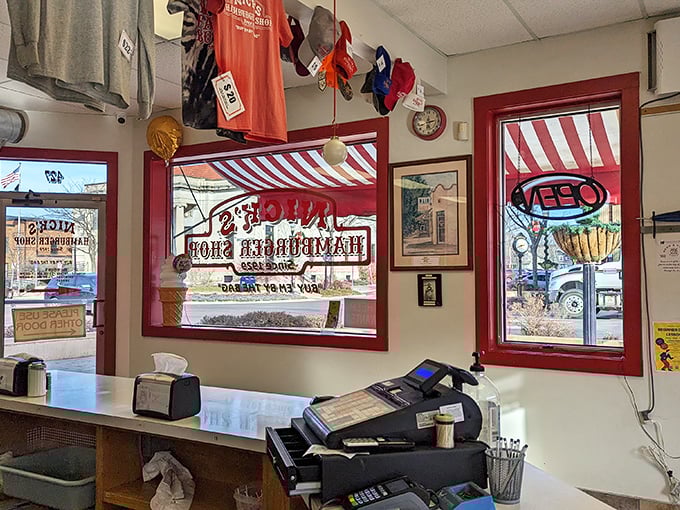 Nick's merchandise hanging proudly alongside chip bags. When your burgers are this good, people want to wear your logo like a badge of honor.
