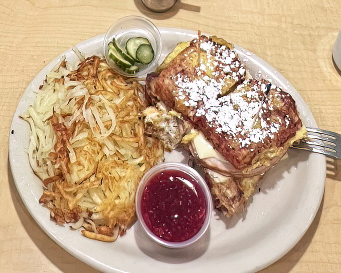 The Monte Cristo sandwich arrives looking like French toast's savory cousin, with powdered sugar, hash browns, and that essential side of cranberry sauce.
