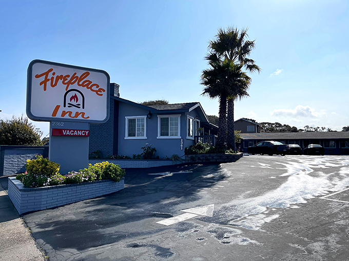 The Fireplace Inn's vintage sign promises cozy accommodations for foggy Monterey nights. Because even paradise gets chilly after sunset.