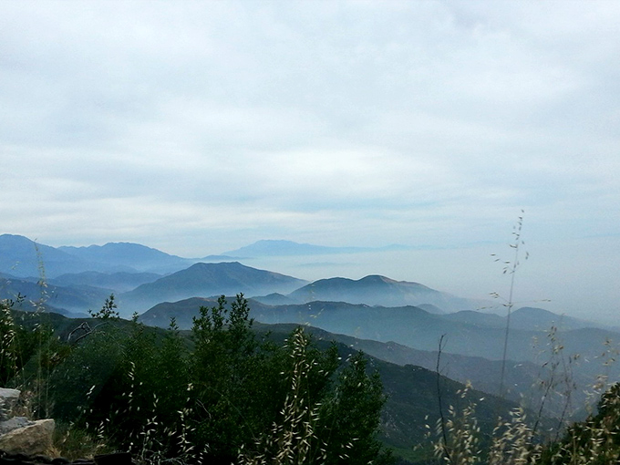 Mountains playing hide-and-seek with the clouds. The layered ridges fade into the distance like echoes of the landscape.