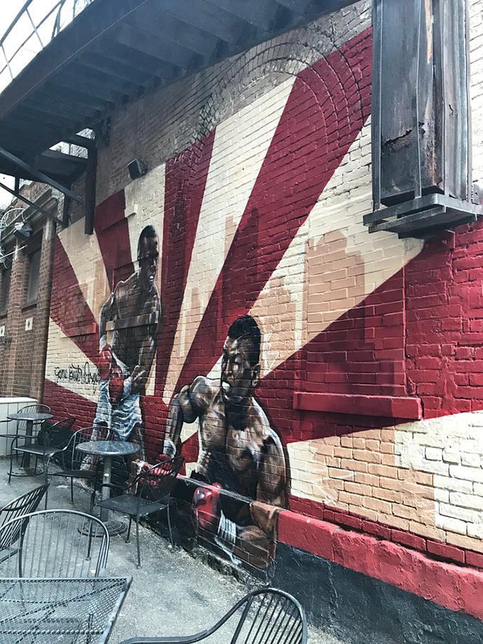 The exterior mural celebrates boxing legends with the same reverence the kitchen shows to classic American comfort food. Art that feeds the soul.