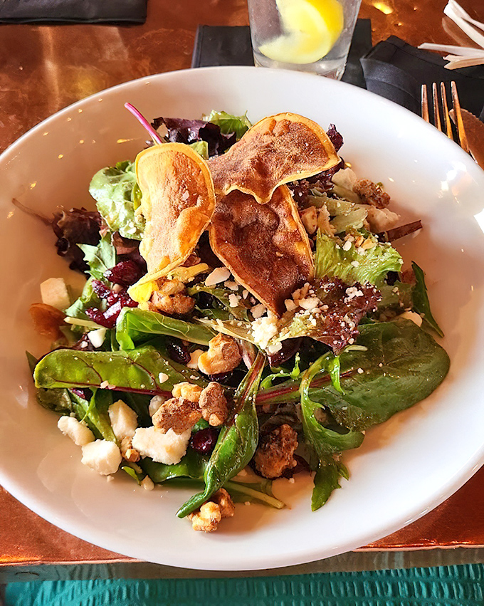 A salad that defies the "rabbit food" stereotype &ndash; crisp greens, crunchy elements, and what appears to be house-made chips create textural symphony.