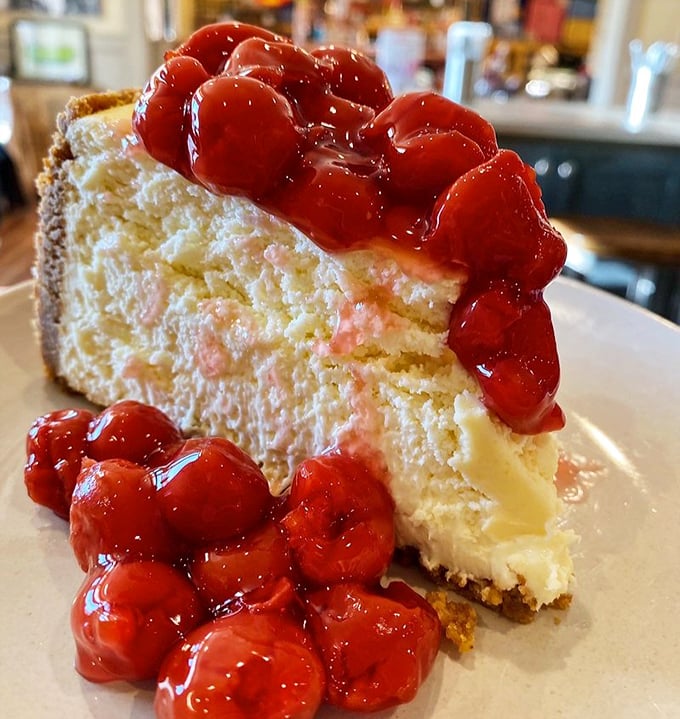 New York cheesecake crowned with cherry jubilee—dense, creamy perfection that makes you wonder why you ever waste calories elsewhere.
