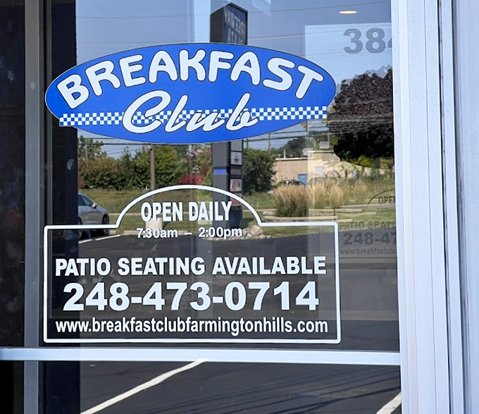 The door sign &ndash; practical information wrapped in blue and white promise. "Open Daily" &ndash; two of the most beautiful words in the English language.