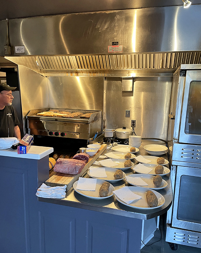 The lineup of potatoes awaiting their destiny. In the background, the grill stands ready for its starring role in the evening's performance.