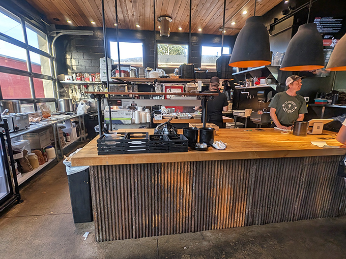 Behind the counter magic where smoke meets meat. The rustic wood and metal aesthetic perfectly frames the serious business of barbecue.