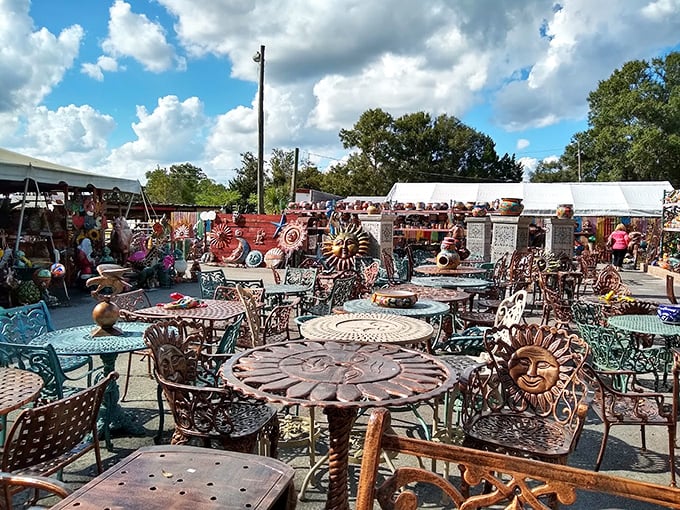 Metal suns, mosaic tables, and artistic chairs create an outdoor gallery where form and function dance together under Florida skies.
