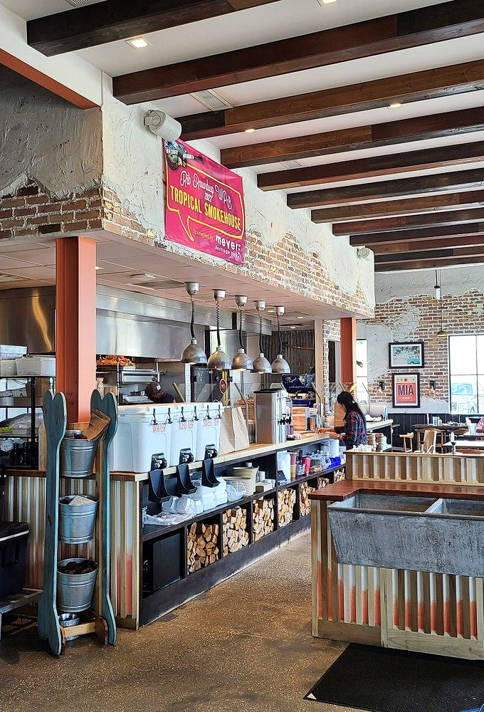 Rustic-industrial charm meets BBQ functionality&mdash;exposed brick, wooden beams, and the promise of smoked delights to come.