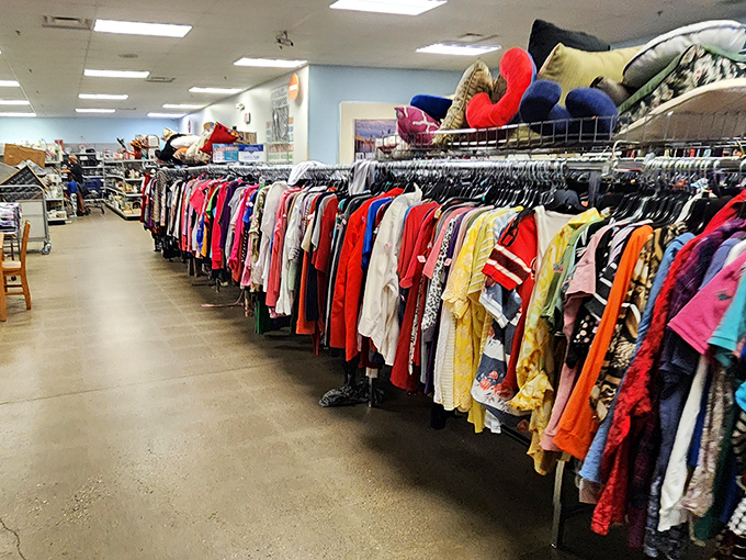 A sea of colorful clothing awaits, each garment with a past life and future possibilities hanging in the balance.