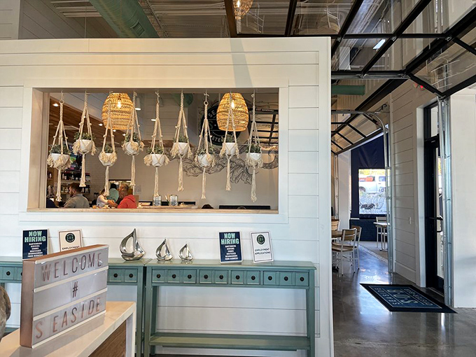 The entrance welcomes you with coastal charm and macram&eacute; plant hangers that somehow avoid being kitschy &ndash; a design feat worthy of HGTV.