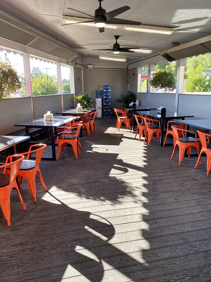 The covered patio area offers a sun-dappled sanctuary for enjoying your Big Bun feast. Those orange chairs practically radiate happiness.