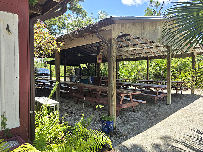 Covered outdoor seating surrounded by palms and ferns creates the perfect Florida dining atmosphere &ndash; no air conditioning required.