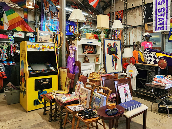 The iconic yellow Pac-Man arcade cabinet stands among vintage furniture&mdash;a pixelated portal to countless quarters spent in 1980s arcades.
