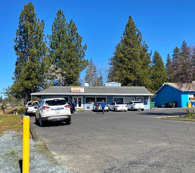 The blue building stands ready for another day of breakfast service, surrounded by pine trees and mountain air. Hunger's last stop.