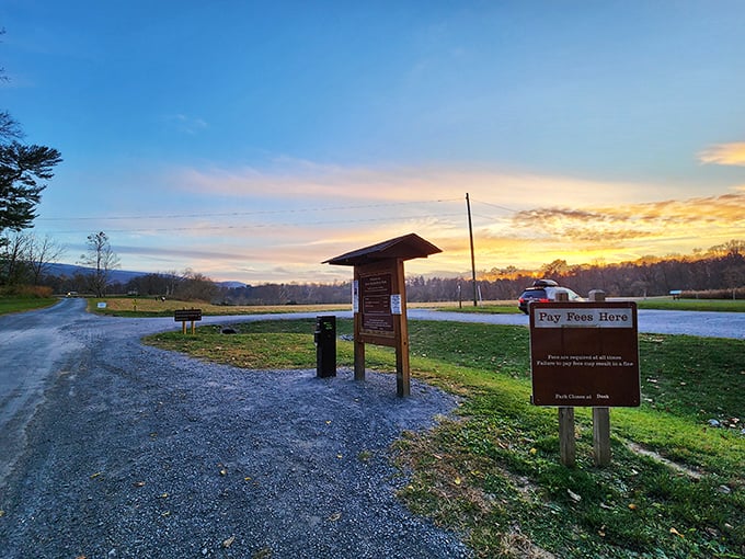 Sunset at the park entrance: nature's way of saying "come back tomorrow" with a technicolor farewell that beats any closing credits.