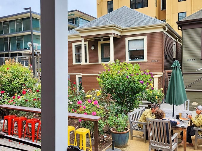 Garden dining that feels like you've stumbled into someone's cherished backyard party. Those colorful stools add a playful touch.
