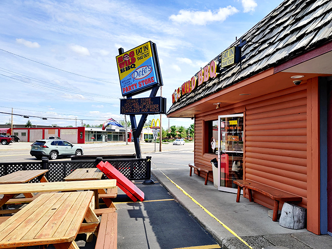 The outdoor seating area—where picnic tables await those who prefer their barbecue with a side of fresh air and Michigan sunshine.