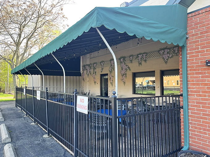 When Ohio weather cooperates, this charming outdoor space becomes prime breakfast real estate. The green awning provides shade for both conversations and hotcakes.