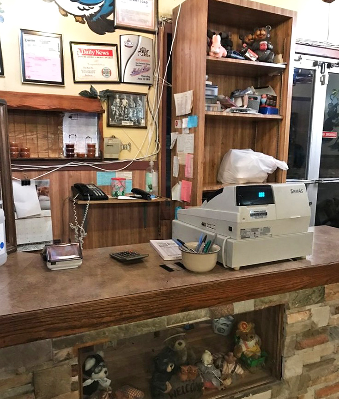 The command center of barbecue operations—where orders are taken, memories are made, and bear-themed knickknacks stand guard over decades of tradition.