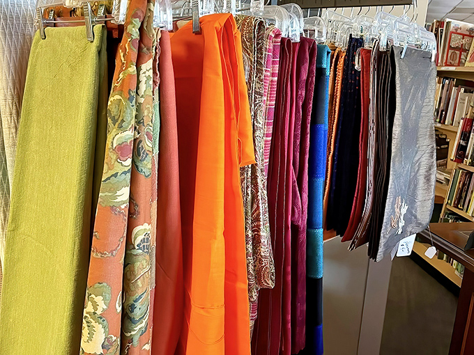 Fabrics in every hue hang like an artist's palette waiting to transform windows, tables, or become that craft project you've been meaning to start.