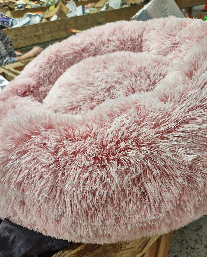 This fuzzy pink pet bed looks so comfortable, you might consider downsizing and moving in yourself. Luxury living for four-legged friends.
