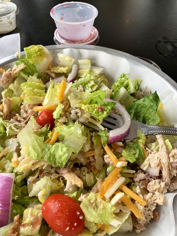 A salad that doesn't apologize for being healthy, because it's loaded with enough smoked chicken to earn its barbecue credentials. Balance achieved.