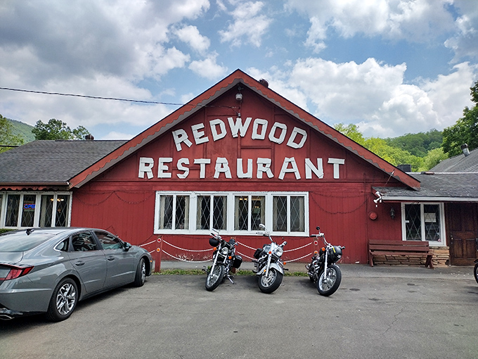 The Redwood Restaurant's barn-red exterior and motorcycle lineup suggest the perfect blend of hearty comfort food and road trip adventure stories.