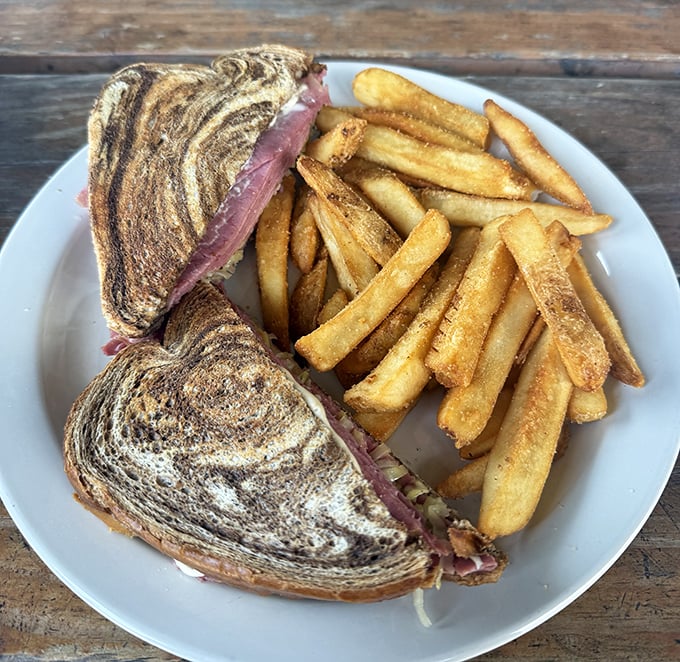 This isn't just a sandwich—it's architecture of flavor, where marble rye creates the perfect foundation for the towering corned beef masterpiece within.