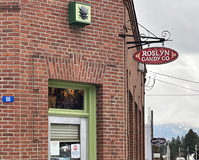 The Roslyn Candy Co. sign swings like a sweet invitation to nostalgic treats that take you back to simpler, sugar-fueled days.