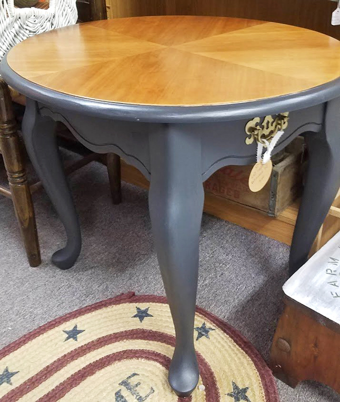 Elegant curves and a two-tone finish make this round table a statement piece. Those Queen Anne legs have more personality than most furniture showrooms.