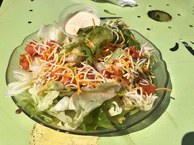 A fresh garden oasis amid fried paradise! This colorful salad offers a crisp counterpoint to the indulgent mains—though we won't judge if you're just making room for dessert.