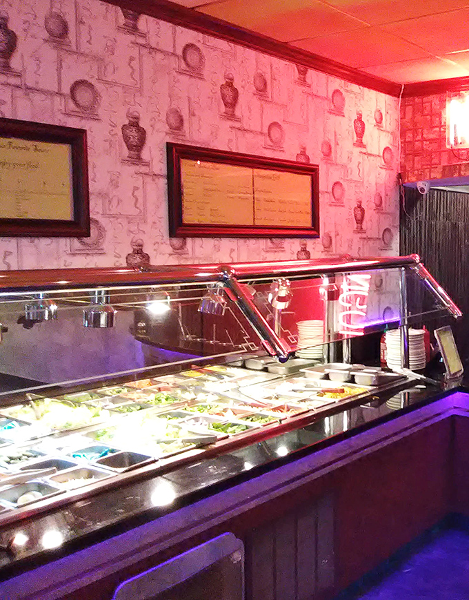 Behind protective glass, a rainbow of fresh ingredients awaits transformation into your next plate of delight—the buffet's promise of abundance made visible.